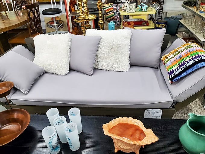 Mid-century modern meets contemporary comfort in this stylish gray sofa, surrounded by vintage glassware that's seen decades of dinner parties.