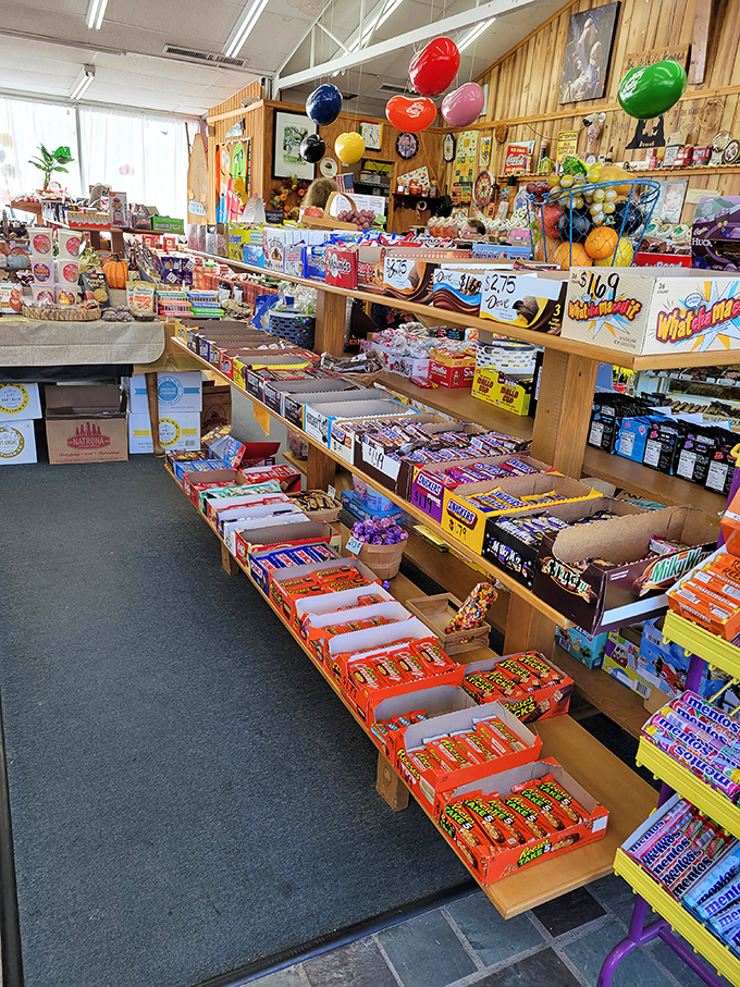 Wooden shelves lined with boxed candies create an organized chaos of sugar possibilities &ndash; like a library where every book guarantees a happy ending.