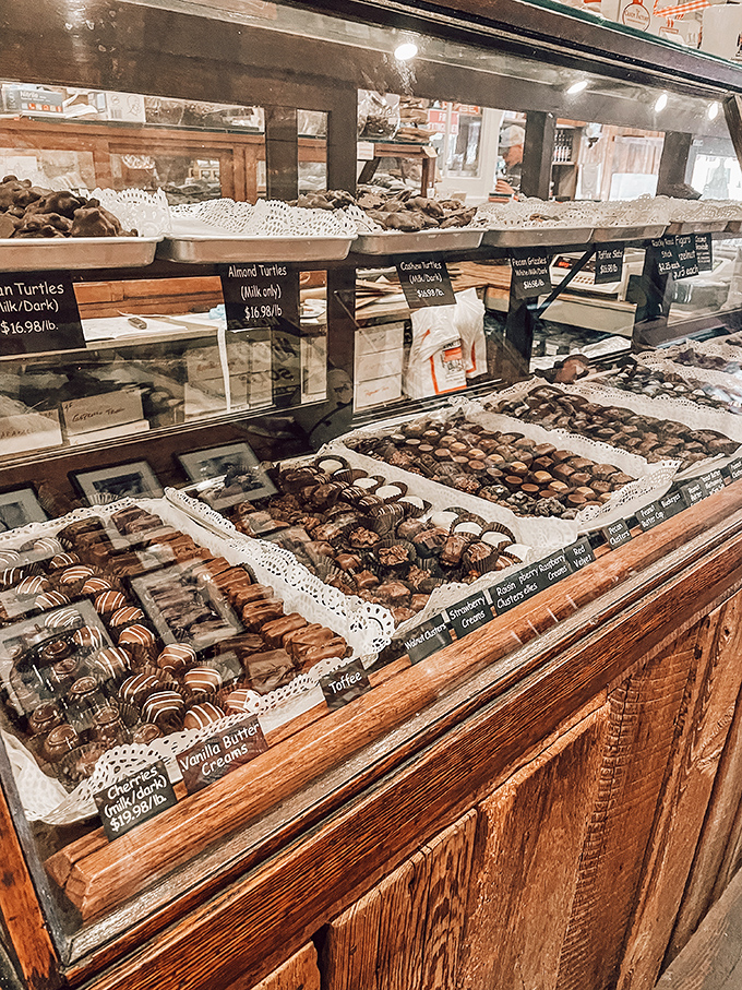 Chocolate temptation on display: turtles, creams, and toffee squares arranged so perfectly that saying "just one piece" becomes life's sweetest lie.
