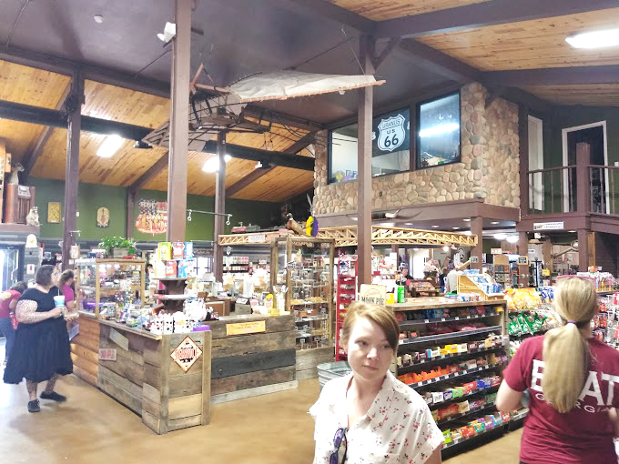 Rustic wooden beams and Route 66 memorabilia create the perfect backdrop for treasure hunting. The store's layout invites exploration through aisles packed with nostalgic finds.