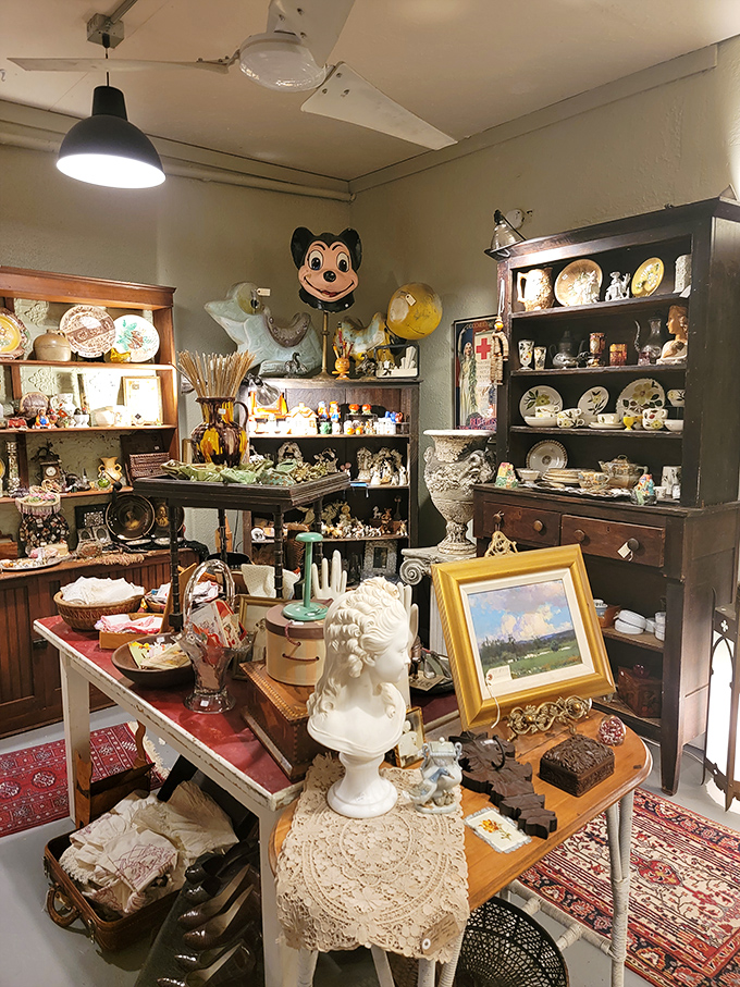 Every shelf tells a different story. This corner alone features classical busts, vintage dishware, and a Mickey Mouse that's seen more decades than Disney+ has shows.