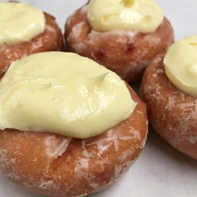 These cream-topped beauties aren't just donuts; they're edible works of art. The vanilla cream sits like a crown atop its glazed throne.