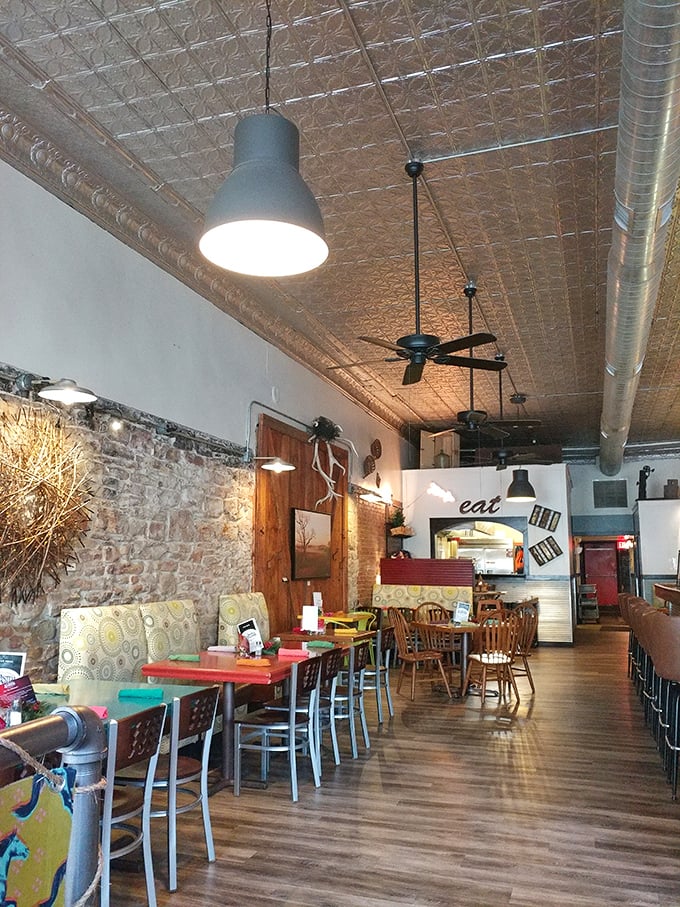Inside Ad Astra, exposed brick walls meet pressed tin ceilings in a space that feels both historically authentic and irresistibly cozy.