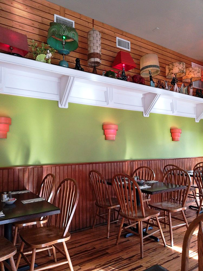 Inside Local Flavor Café, vintage lamps stand sentinel above lime green walls and wooden accents, creating a cozy haven for hungry travelers.