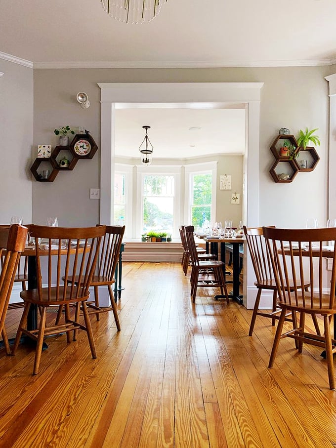 Warm wooden floors and spindle-back chairs create Heirloom's inviting dining space. Sunlight streams through bay windows, highlighting a room where comfort meets sophistication without a hint of pretension.