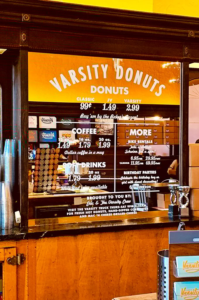 The menu board reveals the simple truth of donut mathematics: reasonable prices plus coffee equals morning salvation for Manhattan's hungry masses.