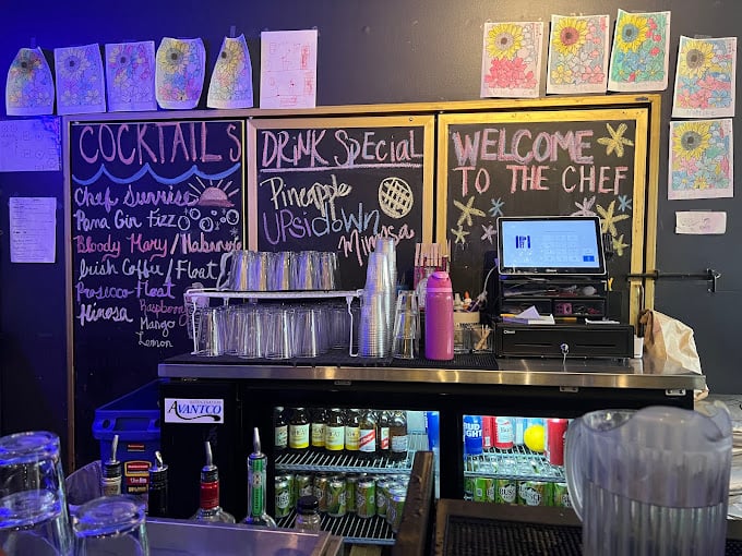 Cocktails and creativity flow together at The Chef's bar, where chalkboard menus showcase libations that elevate the breakfast experience.