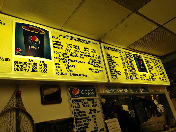 Menu board poetry: where "Po Jack Sammich" sounds like music and the promise of crispy, golden happiness hangs overhead in yellow-lit glory.