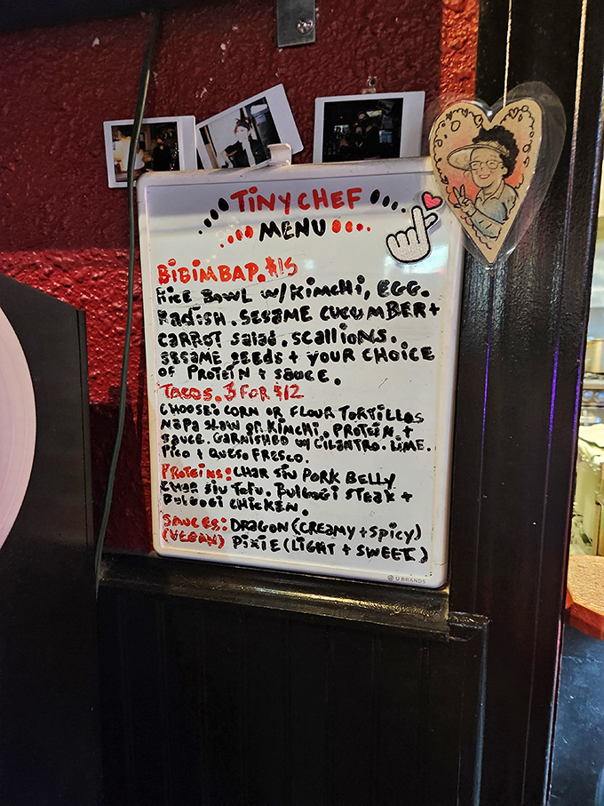 The Tiny Chef menu scrawled in marker feels like finding a secret level in a video game—Korean-fusion tacos and bibimbap hiding in a pinball sanctuary.