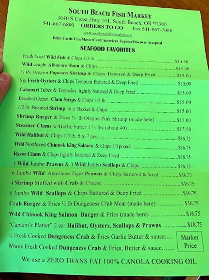 The menu's neon green glow might as well be saying, "Abandon all diets, ye who enter here." Seafood paradise awaits!