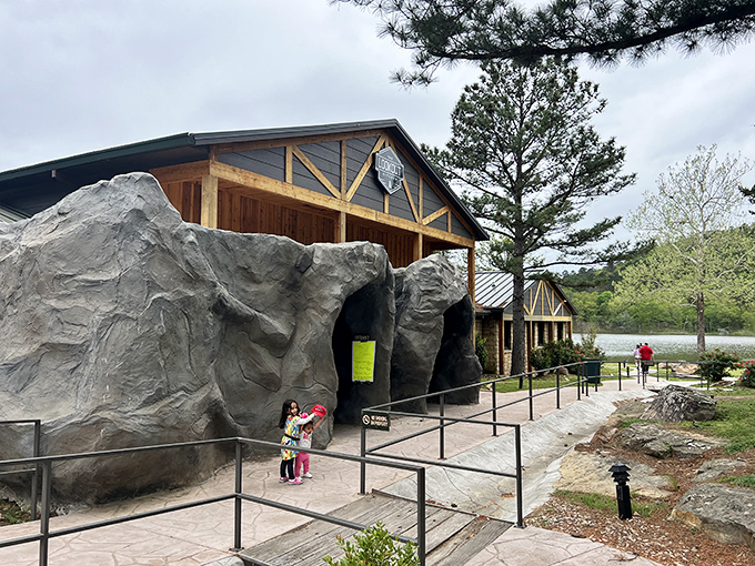 The entrance to Robbers Cave State Park welcomes adventurers with its impressive stone facade, a geological handshake before nature's grand show begins.