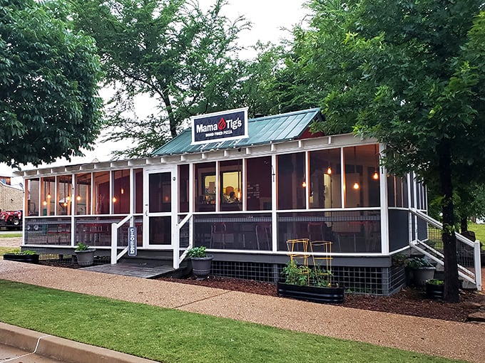 Mama Tig's screened porch isn't just a pizza place; it's therapy with cheese. This wood-fired haven proves paradise exists between crispy crust and evening lake breezes.