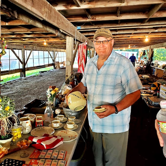 Inside the rustic barn, a vendor proudly displays his collection of vintage dishware&mdash;each piece holding stories of family dinners from decades past.