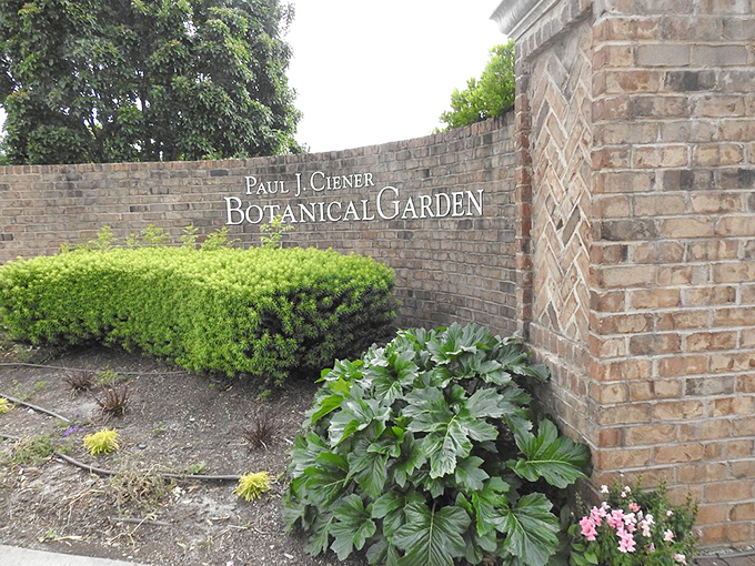The entrance sign promises botanical wonders beyond the brick wall, like finding the garden door to Narnia right in Kernersville.
