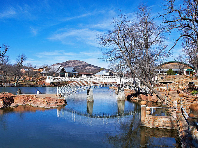 Medicine Park's cobblestone bridge reflects perfectly in crystal waters &ndash; nature's version of a Norman Rockwell painting.