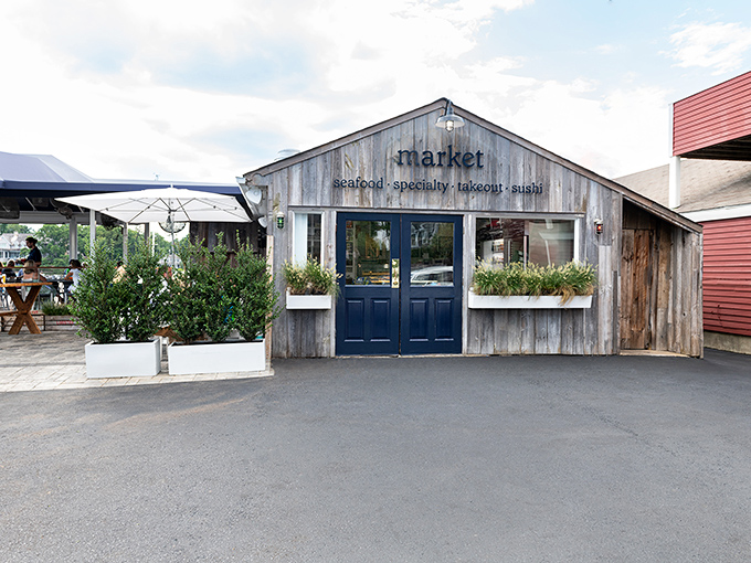 Weathered wood and blue doors at Rowayton Seafood—where "waterfront dining" isn't a marketing gimmick but a geographical fact.