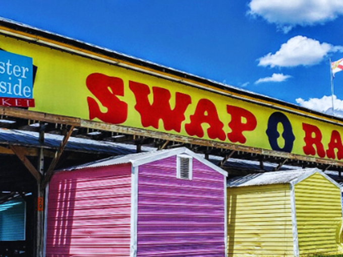 Swap-O-Rama's rainbow of vendor sheds! The cheerful colors hint at the kaleidoscope of bargains waiting inside each little treasure box.