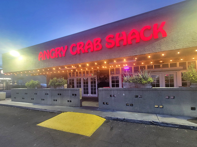 By night, Angry Crab's neon glow transforms from casual eatery to seafood beacon – like a lighthouse for the gloriously butter-stained.