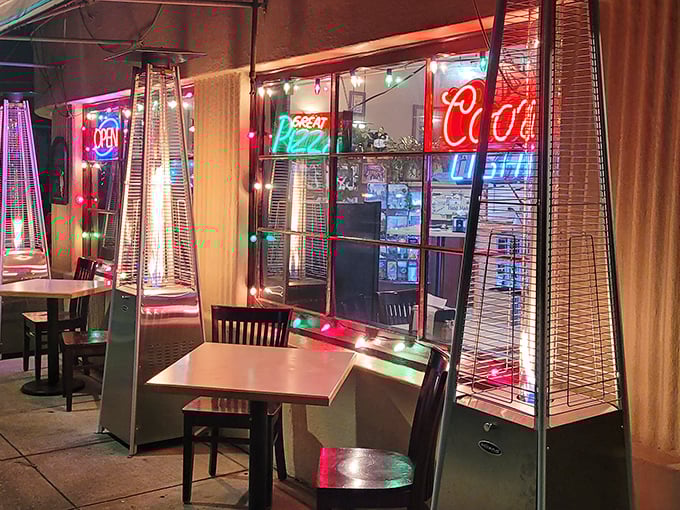 Neon dreams and pizza steam. The warm glow from Beneventi's window has guided hungry travelers like a culinary North Star.