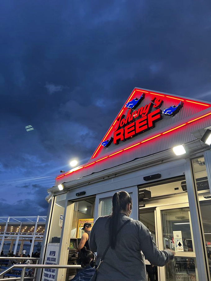 The triangular roof with those glowing blue fish tells you everything: simple seafood done right, with zero pretension and 100% flavor.