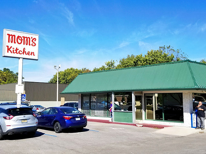 Green roof, simple sign, and a parking lot full of regulars who'd fight you for the last biscuit.