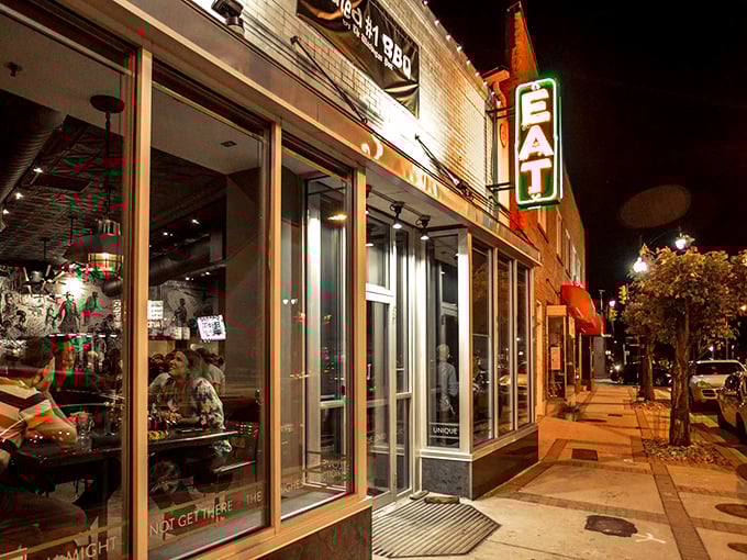 Night falls, but the "EAT" sign glows like a neon promise of smoky satisfaction ahead.