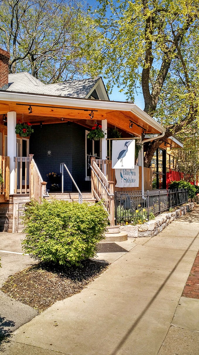 Blue Heron Steakhouse (entrance): "Charming cottage vibes with serious steak credentials. The blue heron sign promises something special inside."