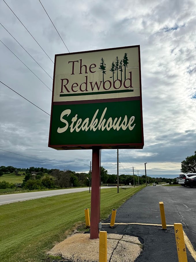 That sign is like a treasure map for carnivores. X marks the spot where perfectly cooked steaks await the hungry traveler.