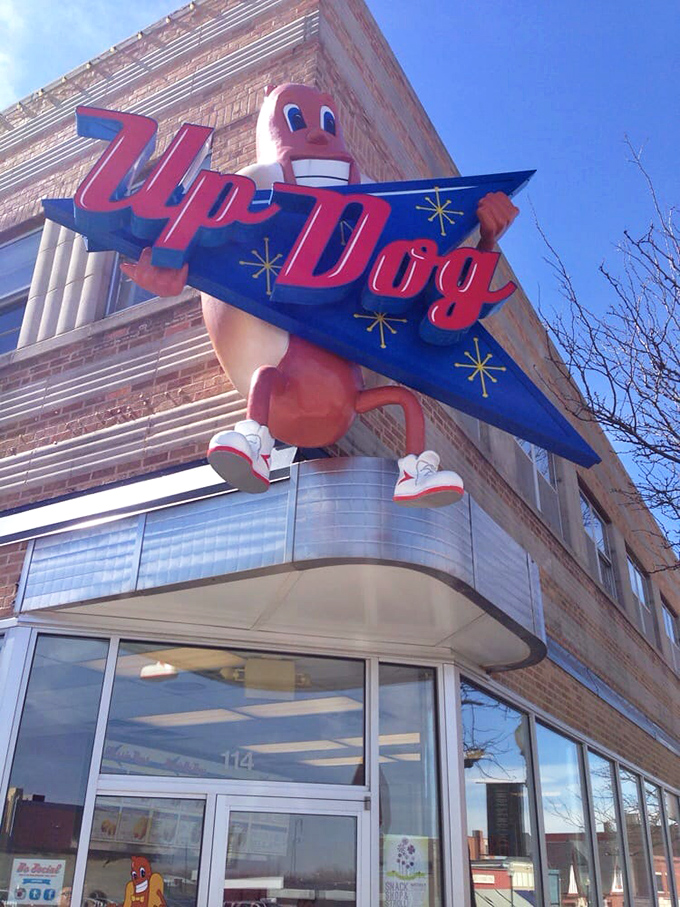 The cheerful hot dog mascot practically dares you not to smile before you've even tasted their regional masterpieces.