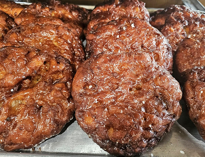 These aren't just apple fritters—they're edible topographical maps of flavor country, with peaks of cinnamon-apple goodness and valleys of perfect glaze.