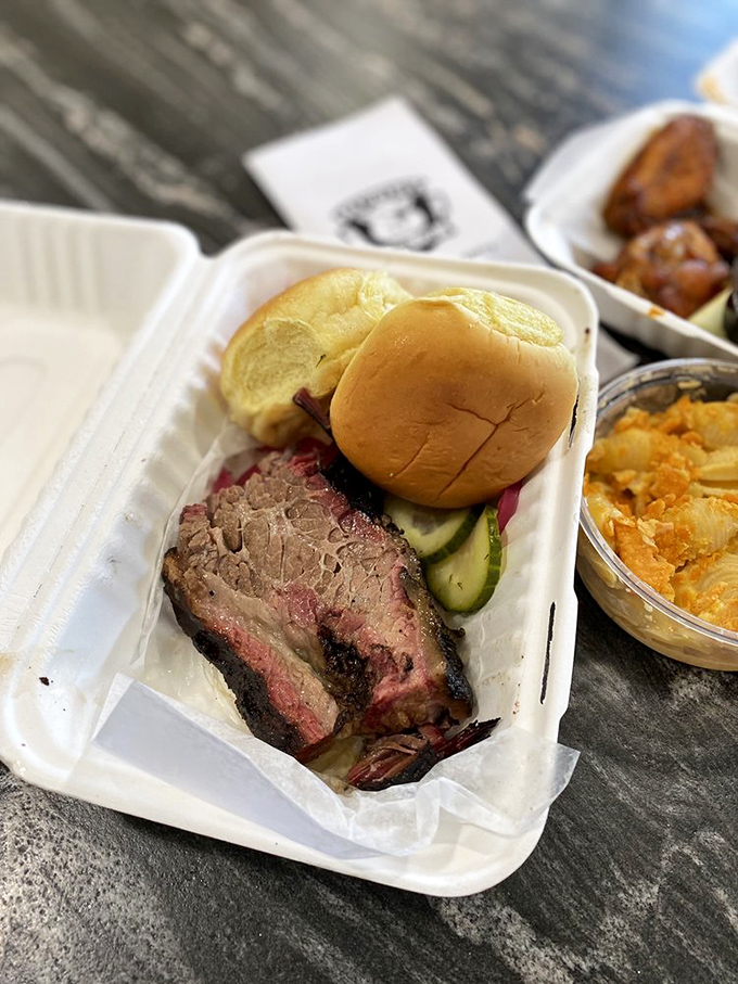 Brisket so tender it practically surrenders to your fork. The pink smoke ring is nature's way of saying "you're welcome."