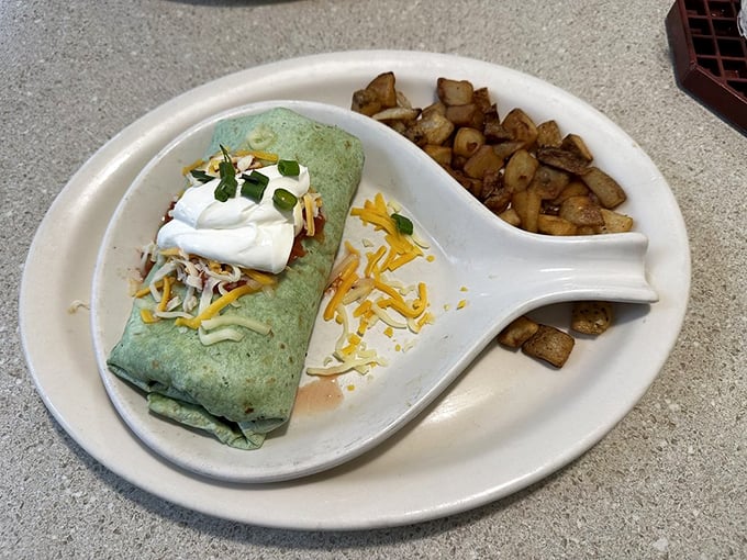 This isn't just a breakfast burrito&mdash;it's morning architecture with perfectly spiced potatoes, melted cheese, and a dollop of sour cream standing guard.