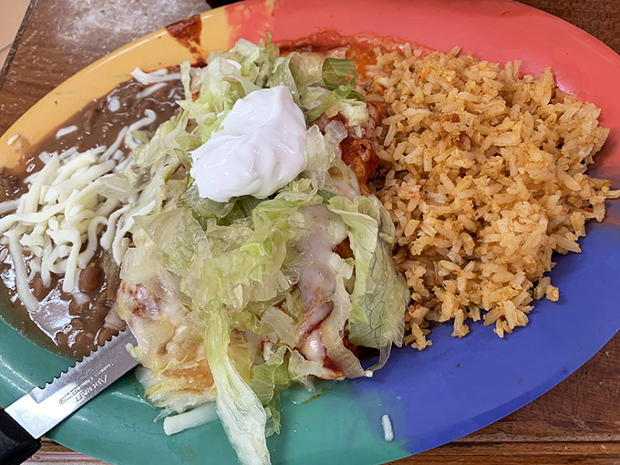 This isn't just an enchilada &ndash; it's a masterclass in balance. Crisp lettuce, melty cheese, and tender chicken nestled in a sauce worth bottling.
