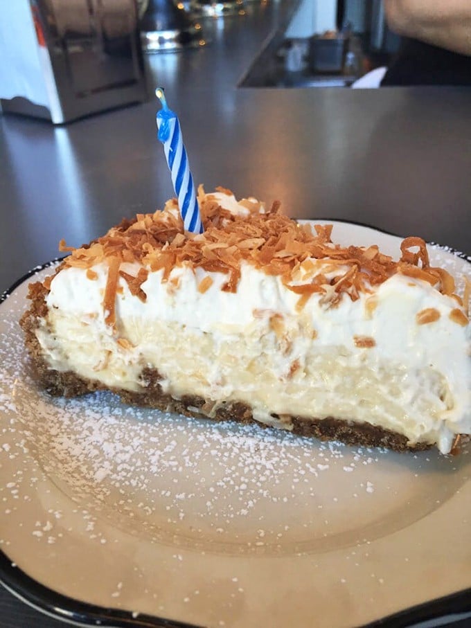 This coconut cream pie with toasted coconut flakes isn't just dessert&mdash;it's a birthday celebration on a plate, complete with candle and dreams.