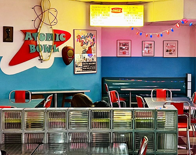 The atomic-age sign pops against color-blocked walls&mdash;mid-century design when America believed the future would look exactly like this.