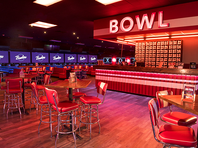 Retro meets modern in this stylish dining area, where red barstools and neon lighting create the perfect atmosphere for post-frame refreshments.