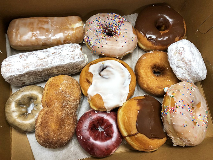 Heaven's assembly line: powdered, glazed, and filled delights standing at attention, ready for their delicious duty.