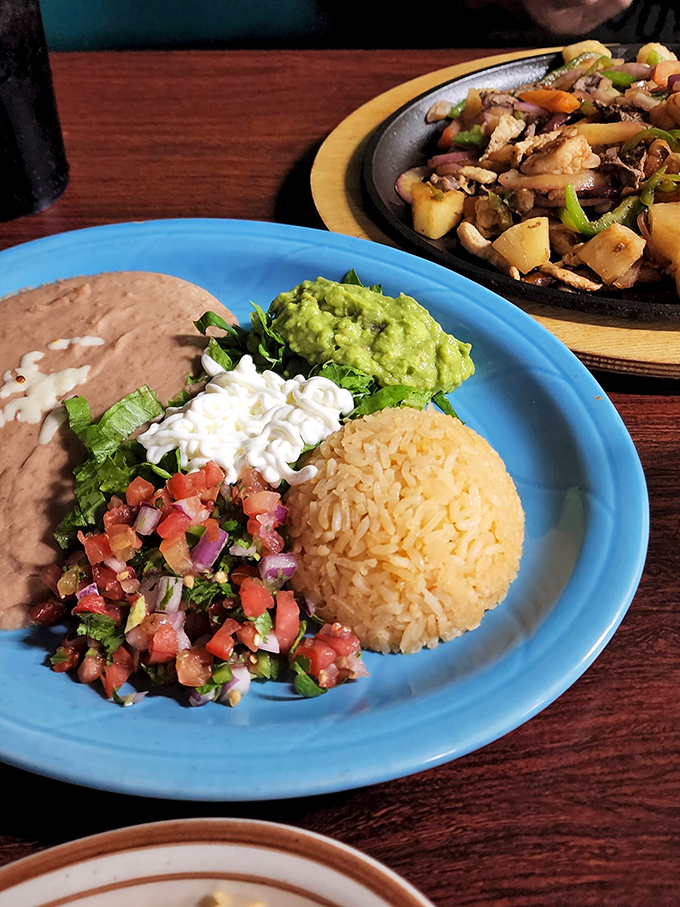 The perfect plate: refried beans with actual texture, rice that's not an afterthought, and pico de gallo so fresh it should have its own farmer's market stand.