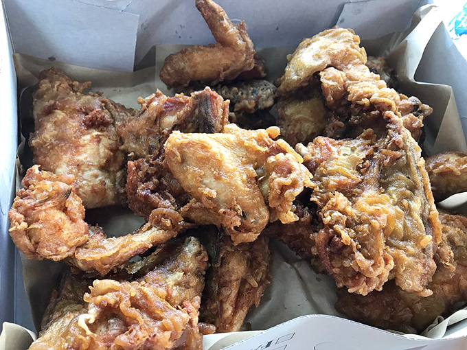 Golden-brown pieces piled high in their paper-lined box &ndash; this isn't just fried chicken, it's edible artwork with a PhD in crispiness.