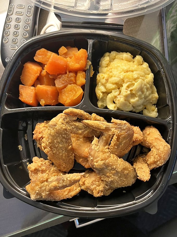 The to-go container that's launched a thousand car picnics. Mac and cheese, candied yams, and chicken that makes traffic jams bearable.
