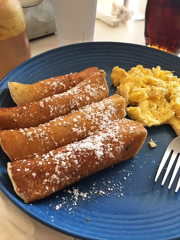 These aren't your childhood pigs in blankets; they're fluffy, golden-brown ambassadors of joy paired with perfectly scrambled eggs.