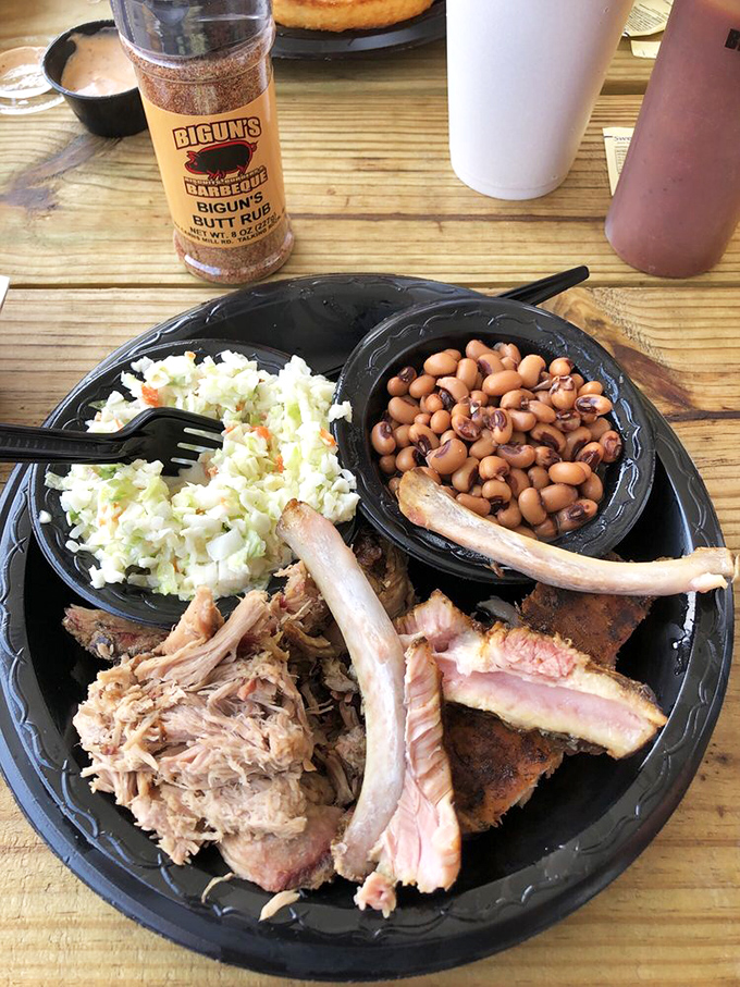 Barbecue nirvana on a plate: tender pulled pork, smoky ribs, creamy coleslaw, and beans that have clearly been simmering with purpose.