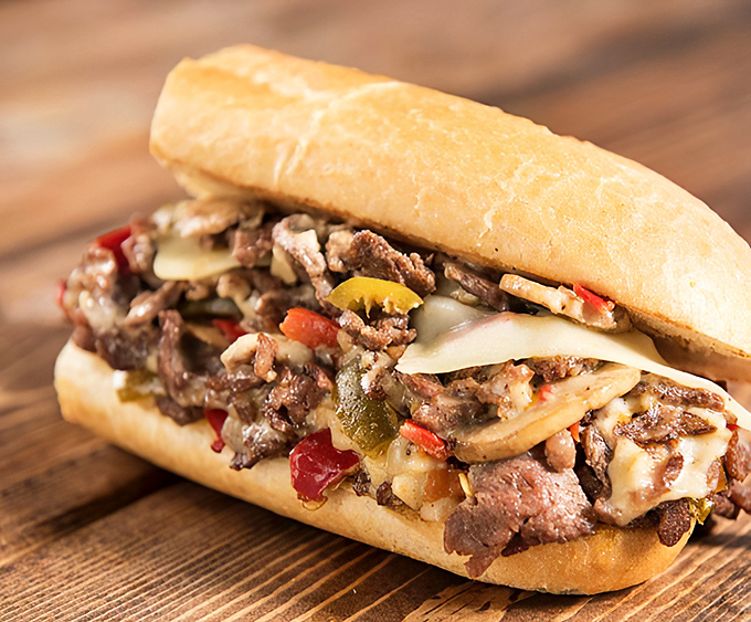 Behold the cheesesteak in its natural habitat &ndash; a perfect marriage of meat, peppers, and cheese that makes wedding vows seem casual.