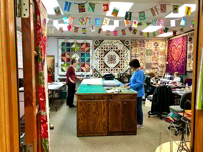 The workspace sanctuary where quilting dreams materialize. Notice how the tables are perfectly sized for fabric wrangling and pattern puzzling.