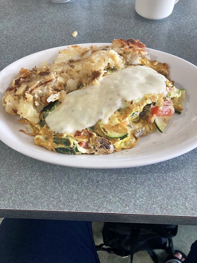 Vegetables finding their higher purpose in life: becoming part of this glorious omelet. That cheese blanket isn't just melted&mdash;it's embracing.