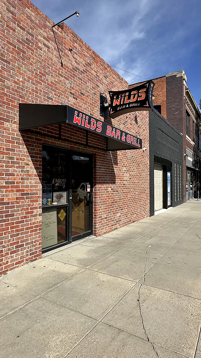 At Wilds Bar & Grill, the brick exterior promises what every road-weary traveler hopes for: cold drinks and hot meals without pretension.