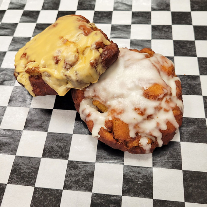 Two paths to paradise: vanilla-glazed perfection meets its caramel-topped cousin on a checkered battlefield where everyone wins, especially your taste buds.