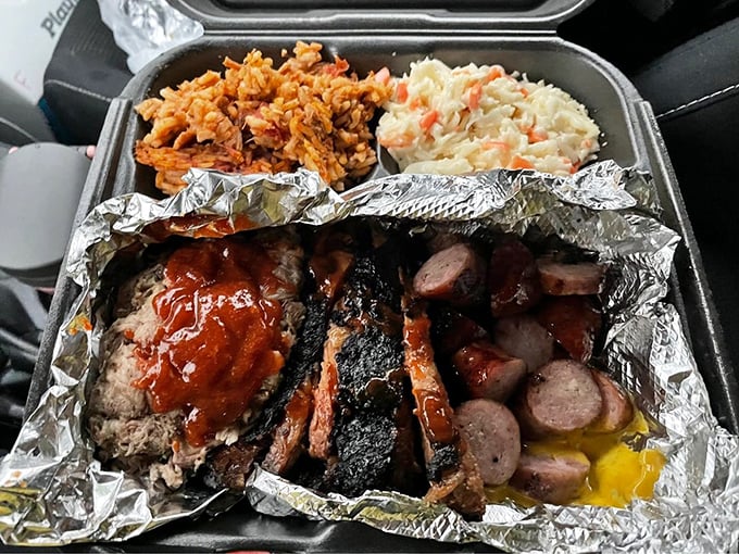 Like a perfectly balanced quartet, this plate harmonizes smoky sausage, golden cornbread, creamy mac & cheese, and seasoned rice into a symphony of satisfaction.