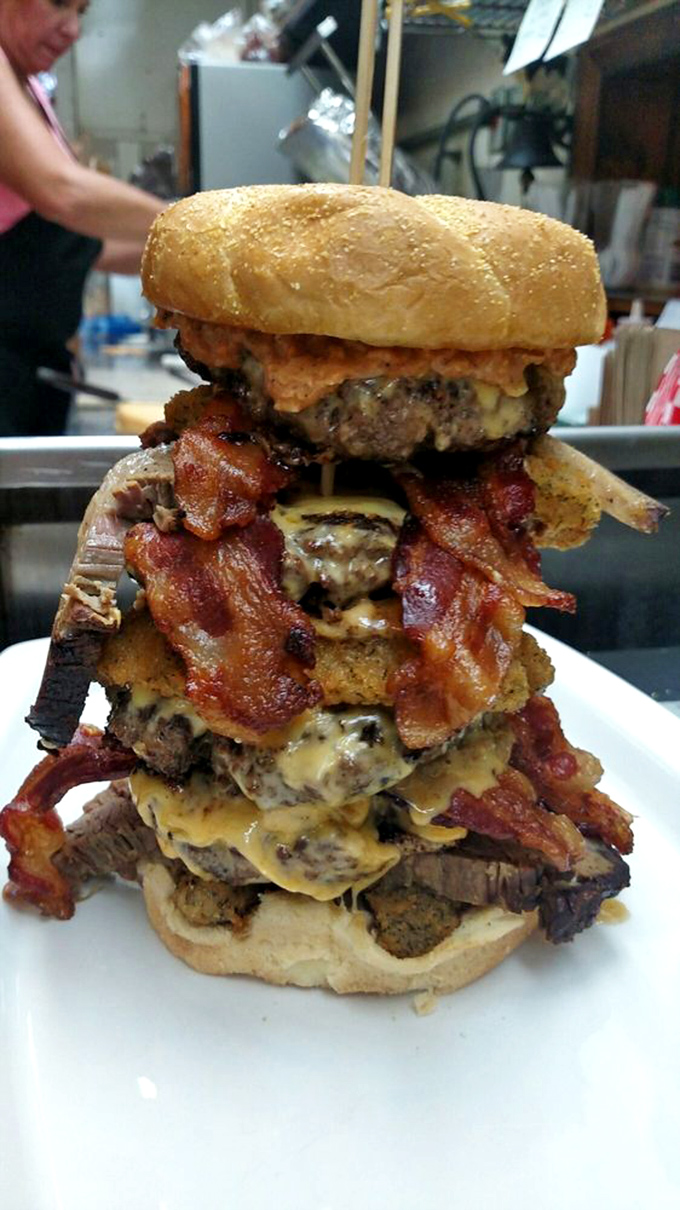Not so much a burger as an engineering marvel. This towering masterpiece makes the Leaning Tower of Pisa look structurally sound.