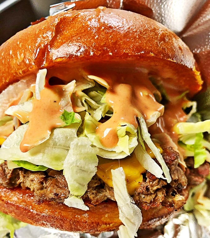 This isn't just a burger&mdash;it's architecture. The golden bun cradles a perfect patty while shredded lettuce and special sauce create a harmony that makes taste buds sing.